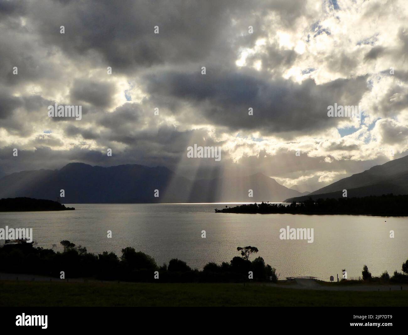 Sun rays peeking through clouds hi-res stock photography and images - Alamy