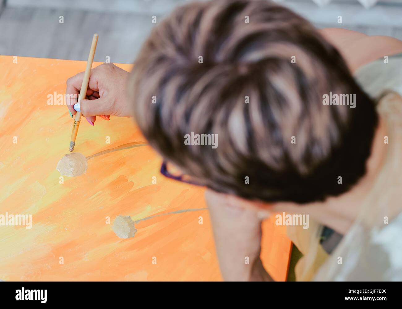 senior woman painting with brush, top view. retire lady hobby ...