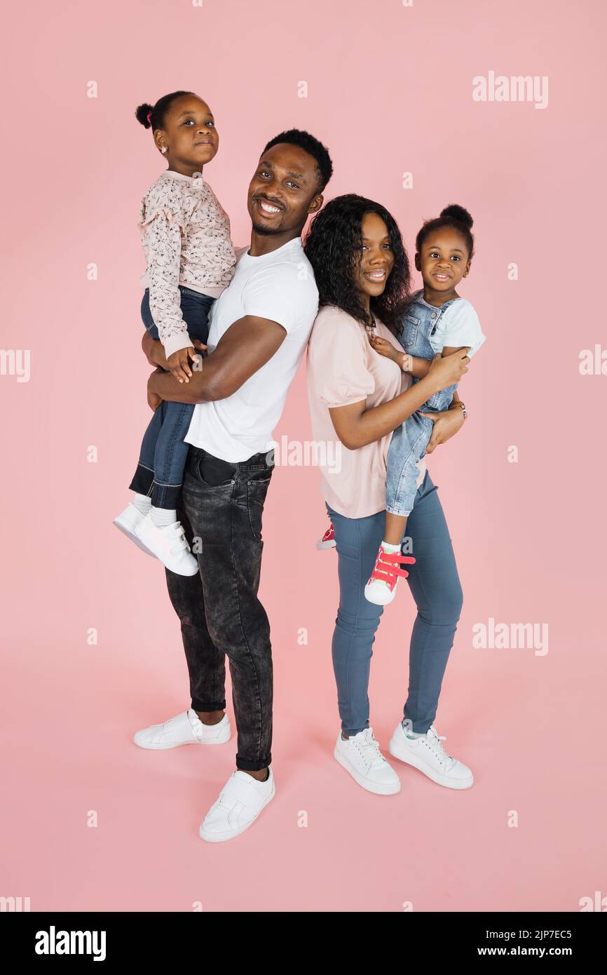 Loving family. Happy african parents and two daughters embracing each ...