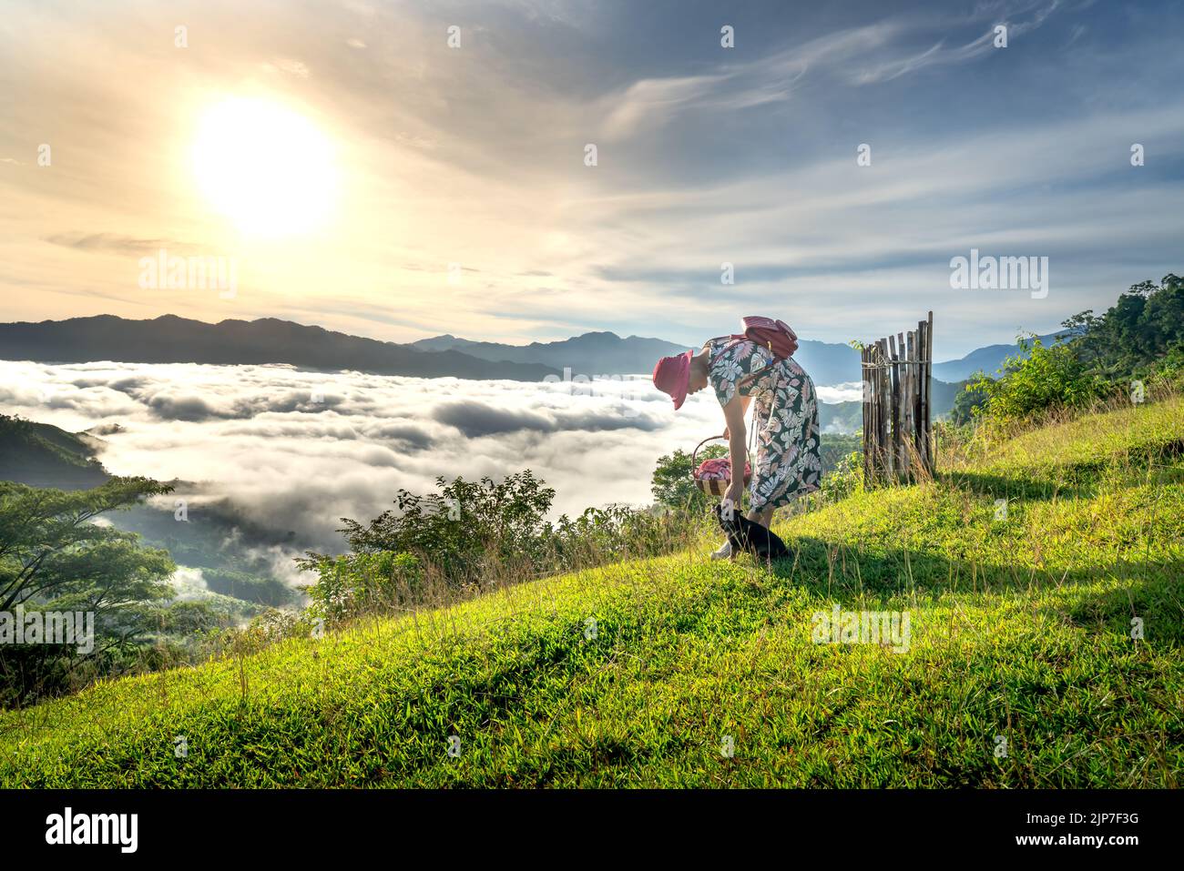 A female tourist looks at the valley full of white clouds in the Tak Po ...
