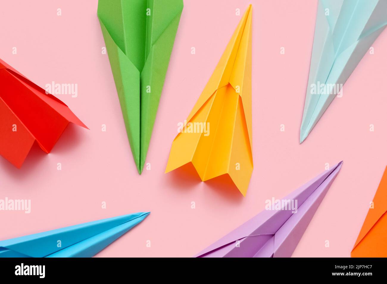 Colorful paper planes on pink background Stock Photo - Alamy