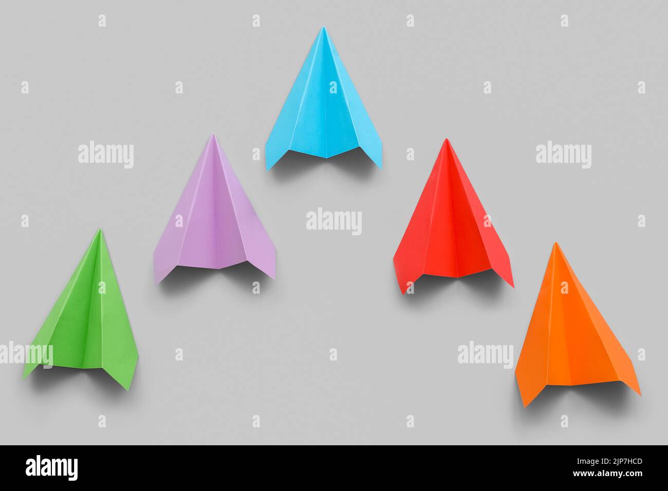 Colorful paper planes on grey background Stock Photo - Alamy