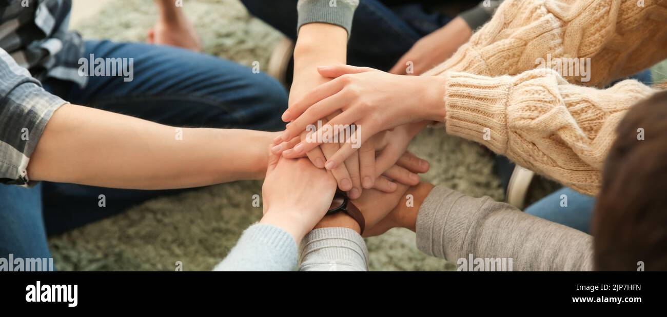 Group of people putting hands together, closeup Stock Photo - Alamy