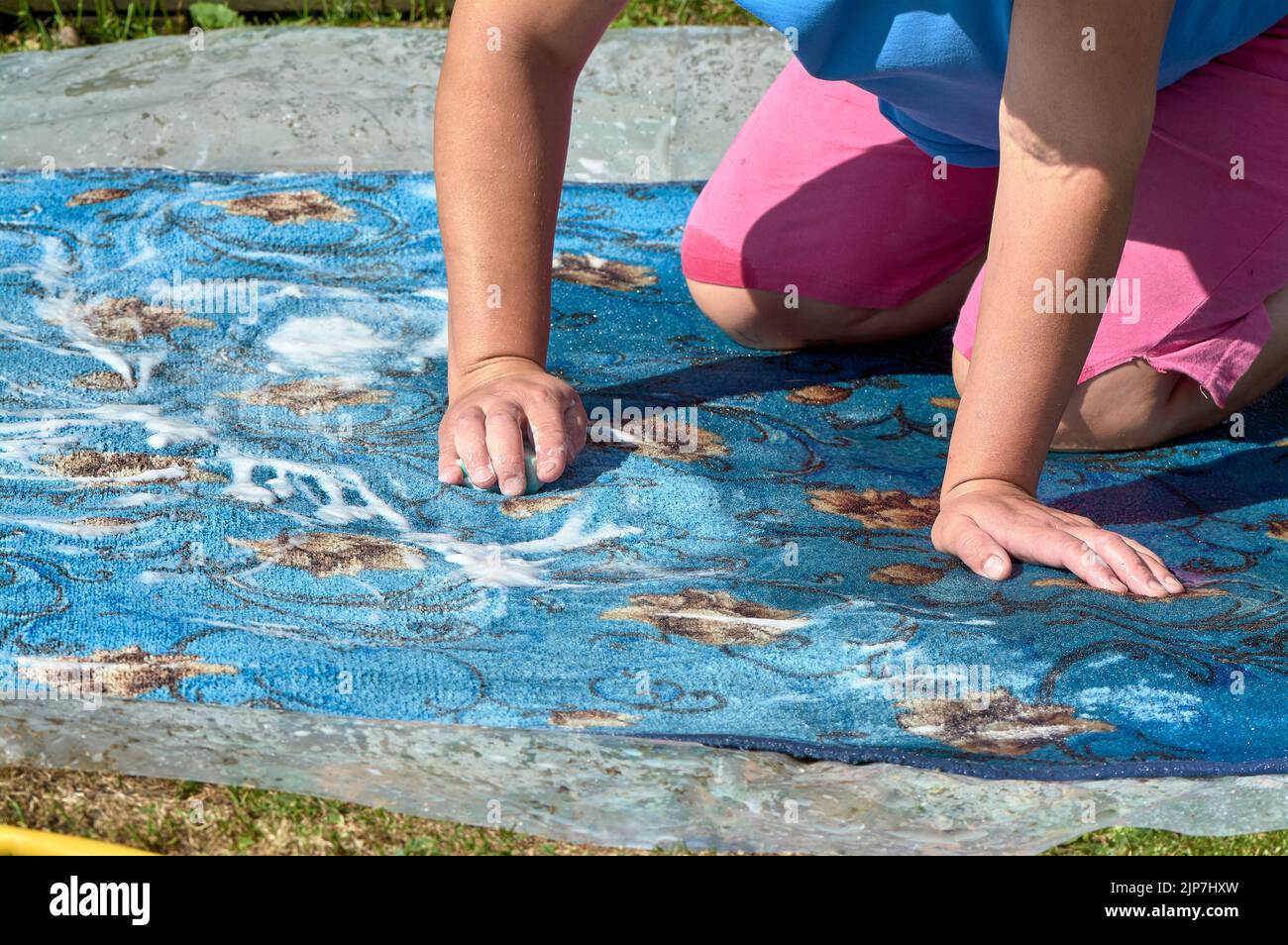 soaping the carpet, washing the carpet on the street Stock Photo - Alamy