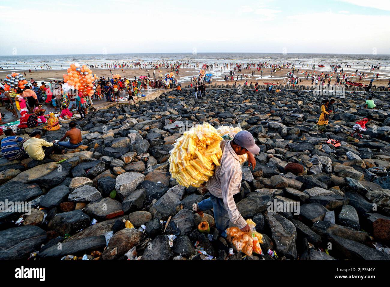 Digha, India. 15th Aug, 2022. A vendor seen walking with his food items ...
