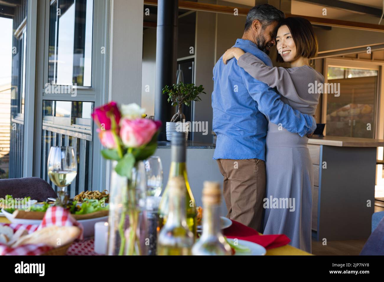 Happy diverse couple dancing together and smiling in dining room Stock ...