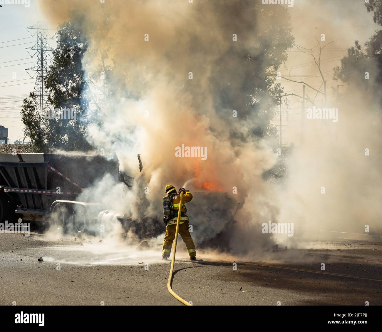 A firefighter with heavy smoke around him Stock Photo - Alamy