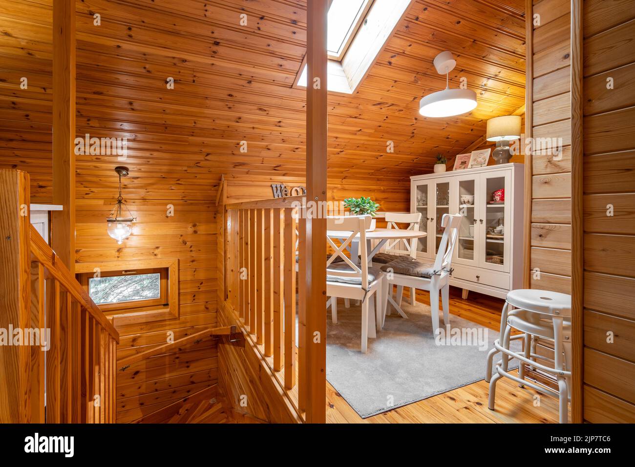Stairs and dining room with table and chairs on the second floor of ...