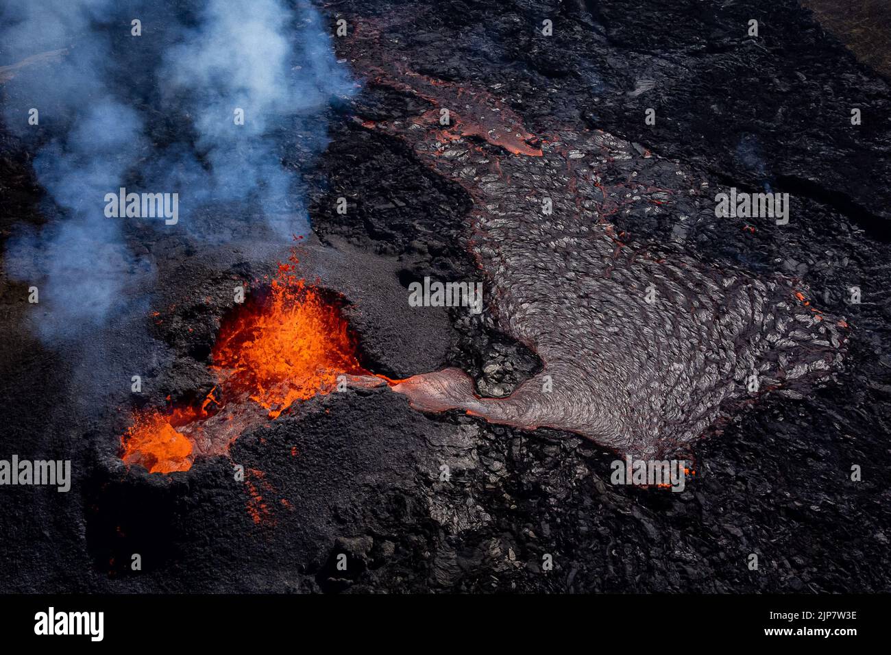 Magma flows from a heart shaped crater at the volcano in Fagradalsfjall ...
