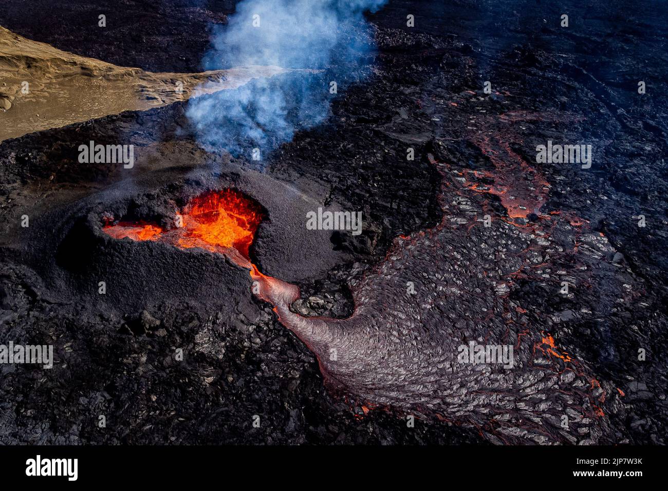 Magma flows from a heart shaped crater at the volcano in Fagradalsfjall ...