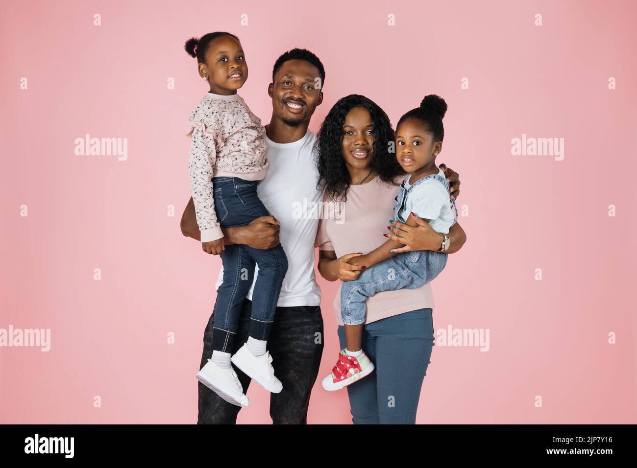 Loving family. Happy african parents and two daughters embracing each ...
