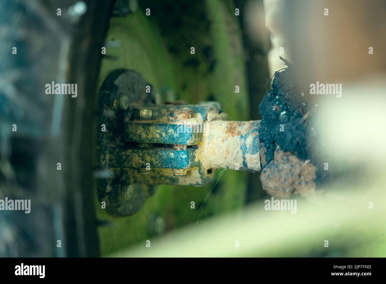Wheel hub of a rural walk-behind tractor close-up. Semi-axle of a ...