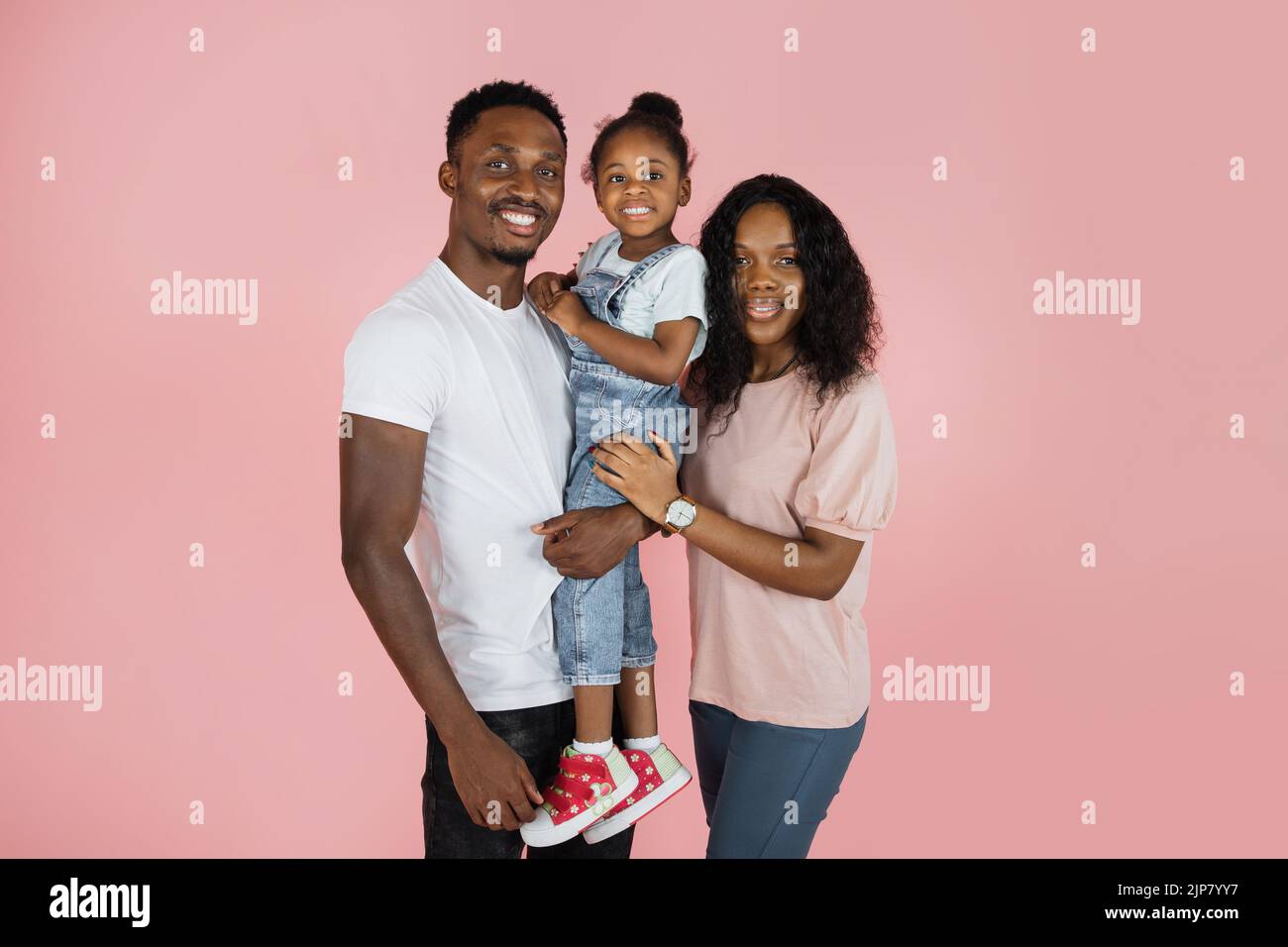Loving family. Happy african parents and their daughter embracing each ...