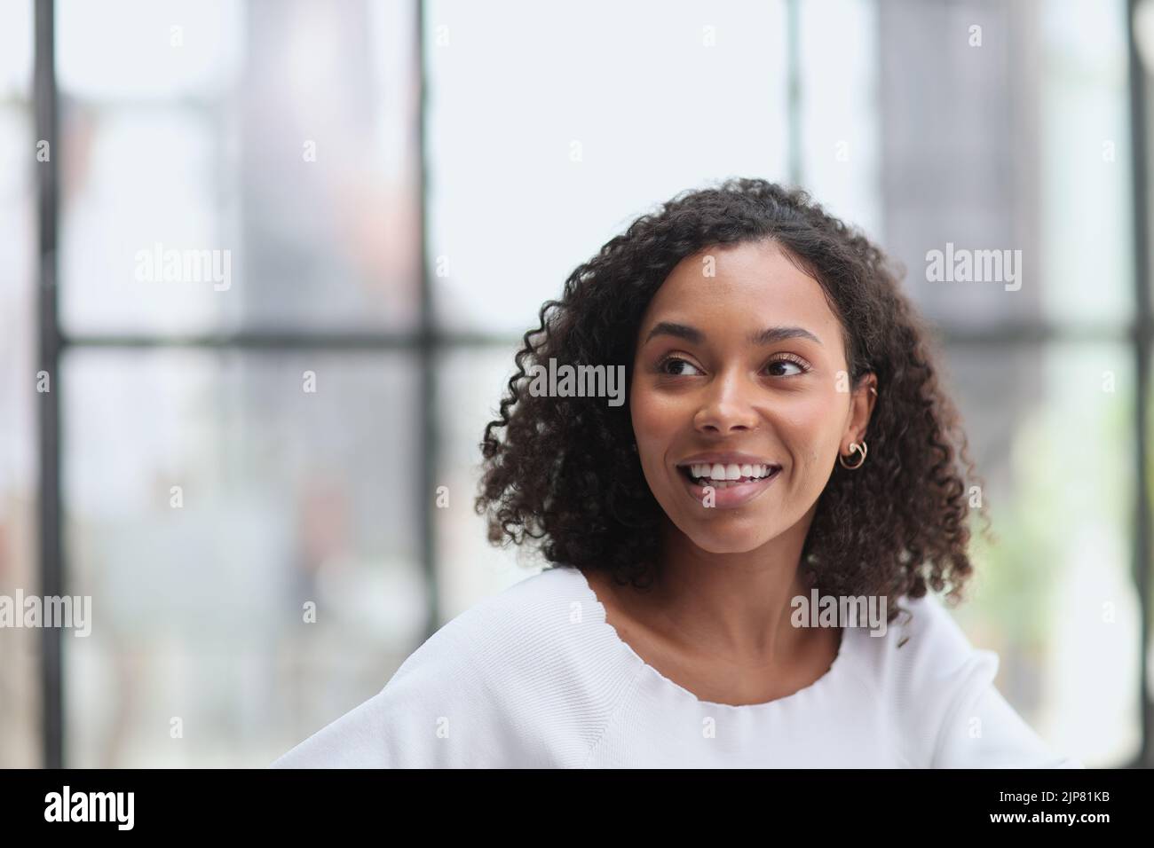 Happy business woman smiling inside office building Stock Photo - Alamy