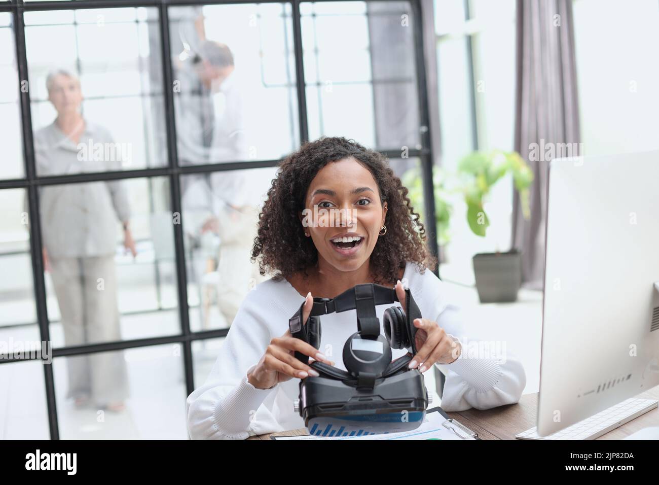 Girl in VR glasses of virtual reality with gamepad playing game Stock ...