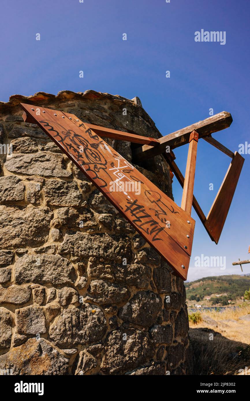 Abandoned windmill with wood blades in Santiago's road. These were ...