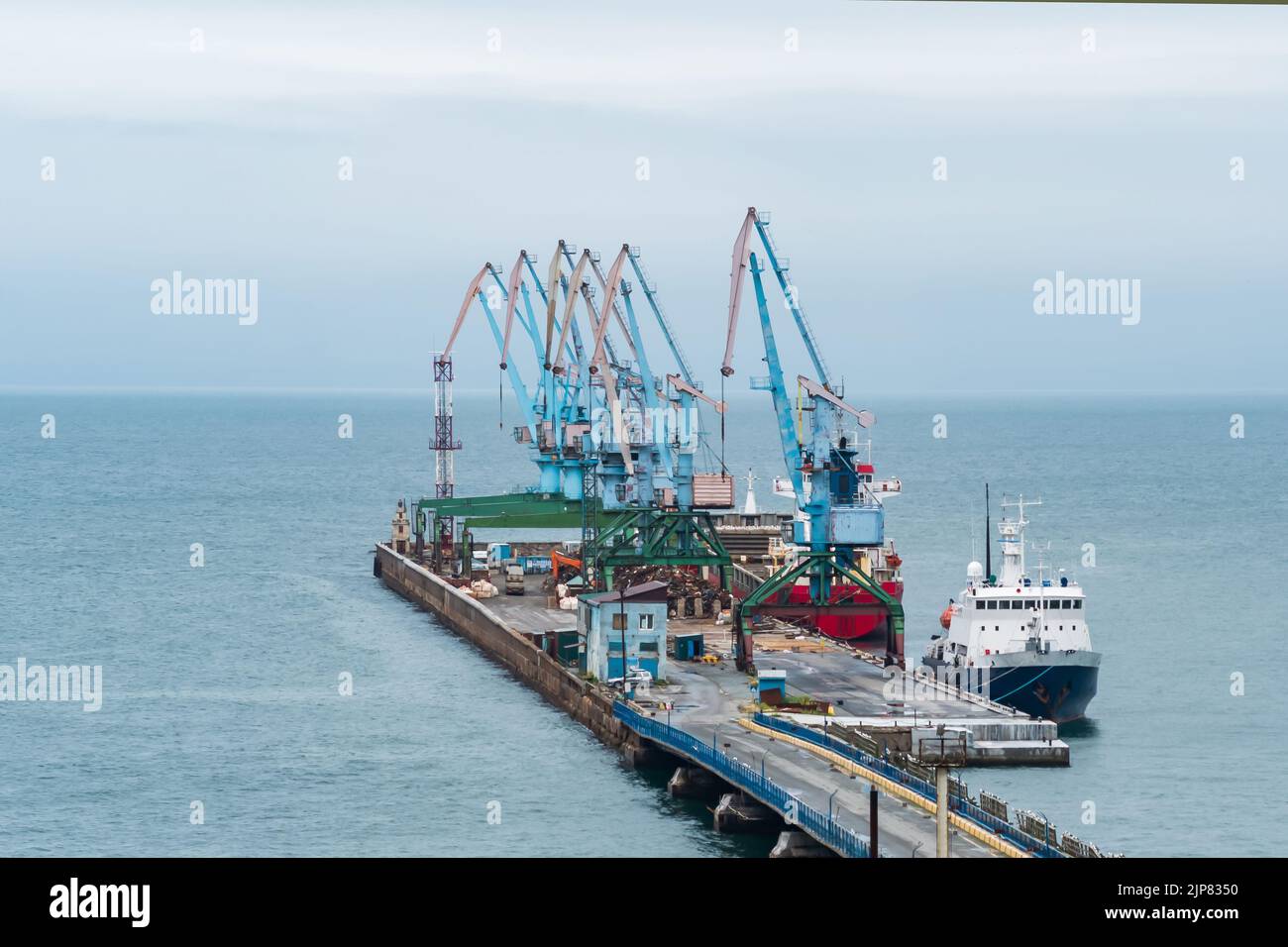 cargo berth with port cranes and moored ships against the backdrop of ...