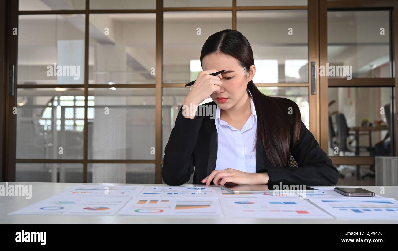 Stressed businesswoman thinking find solution problem of work ...
