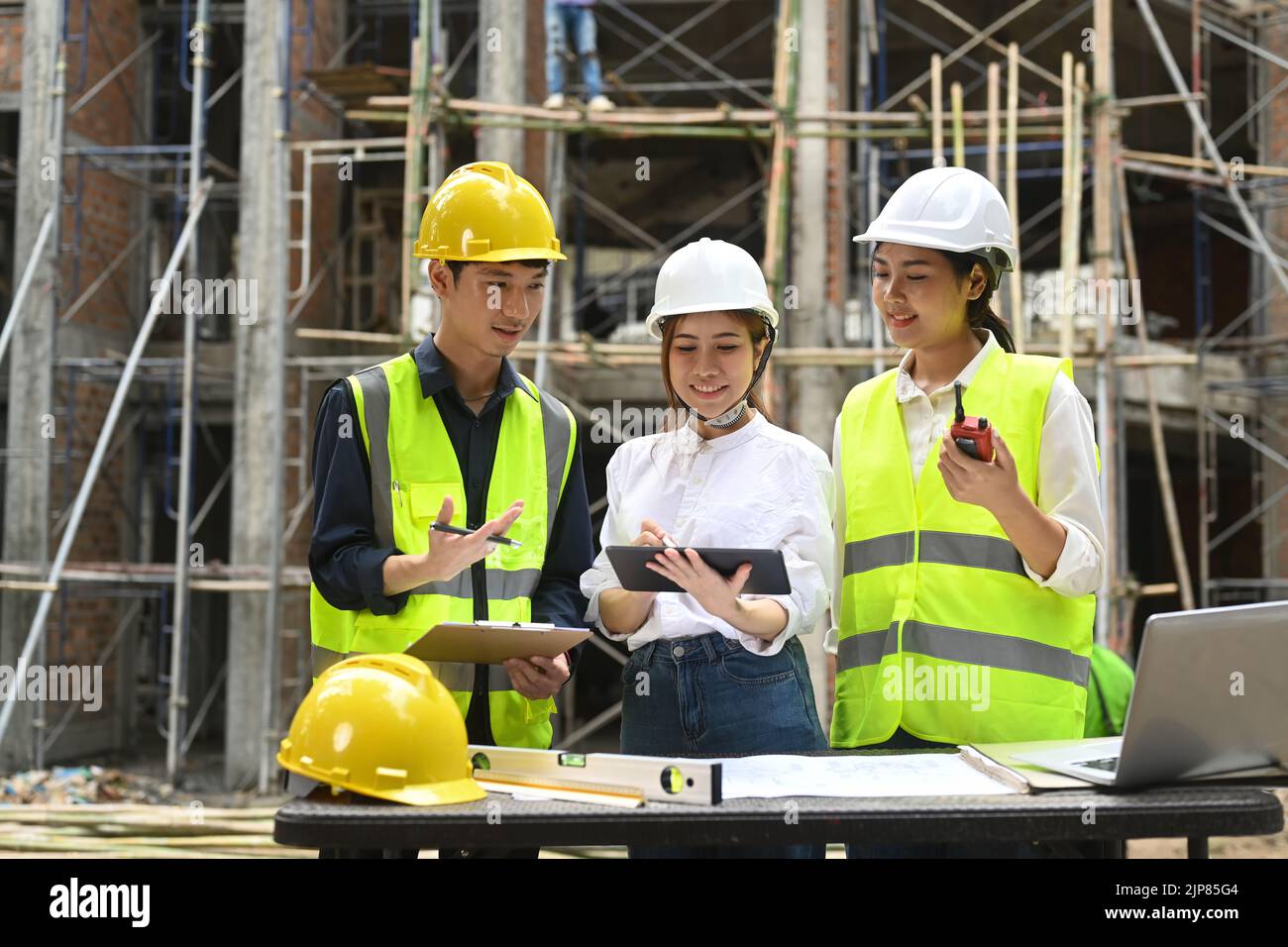 Engineers team wearing safety helmet and vest inspecting industrial ...