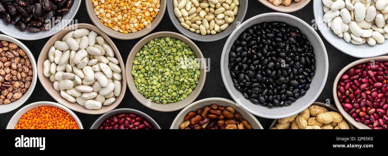 Banner of different types of legumes in bowls, green with yellow peas ...