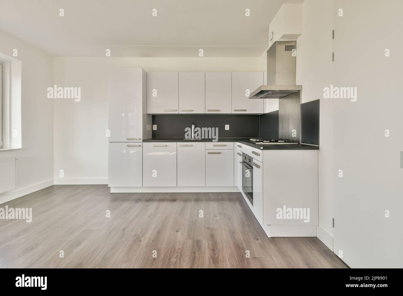 Interior of empty white kitchen with windows and wooden parquet floor ...