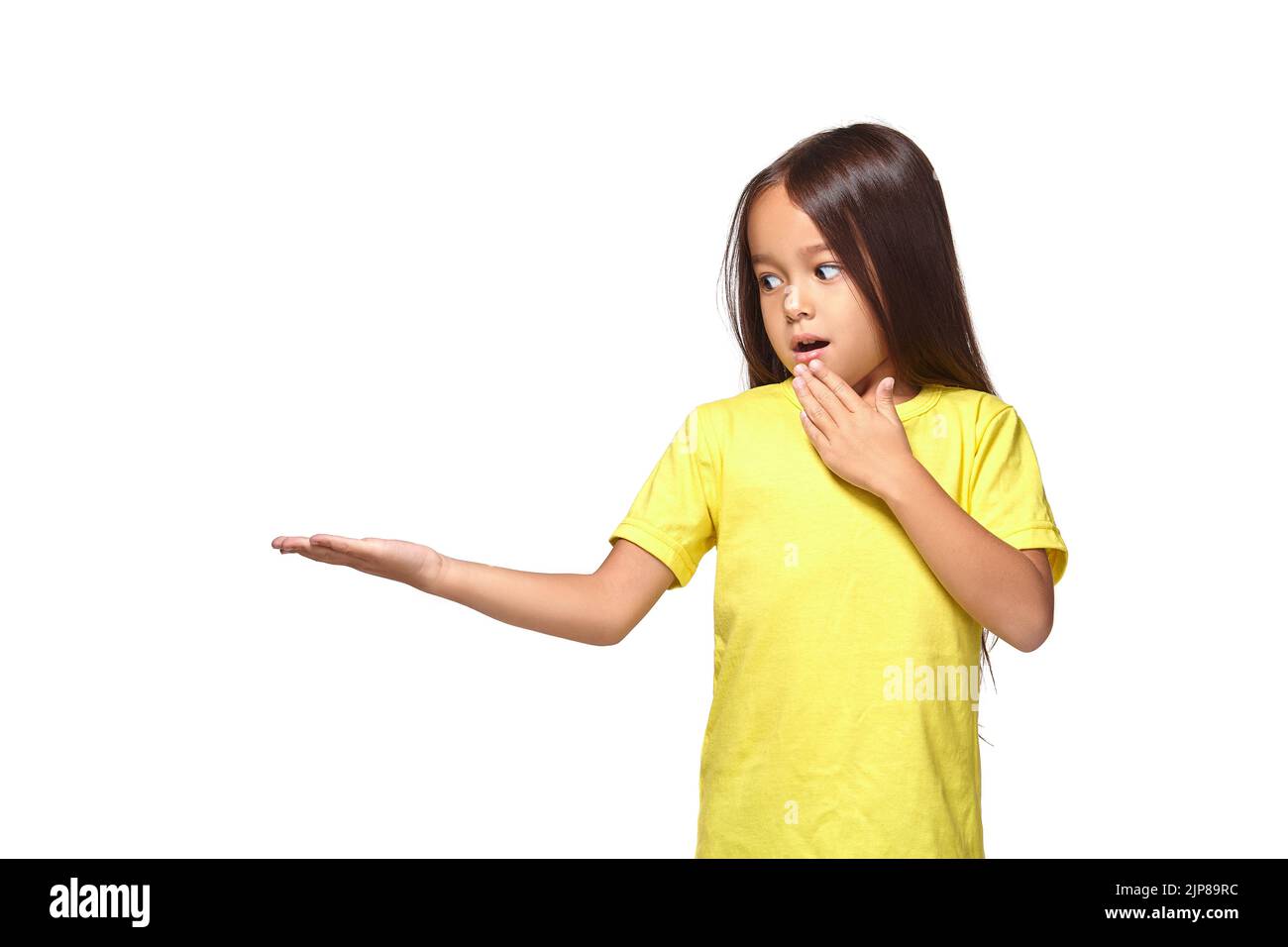 Little girl in yellow t-shirt holding her hand out Stock Photo - Alamy