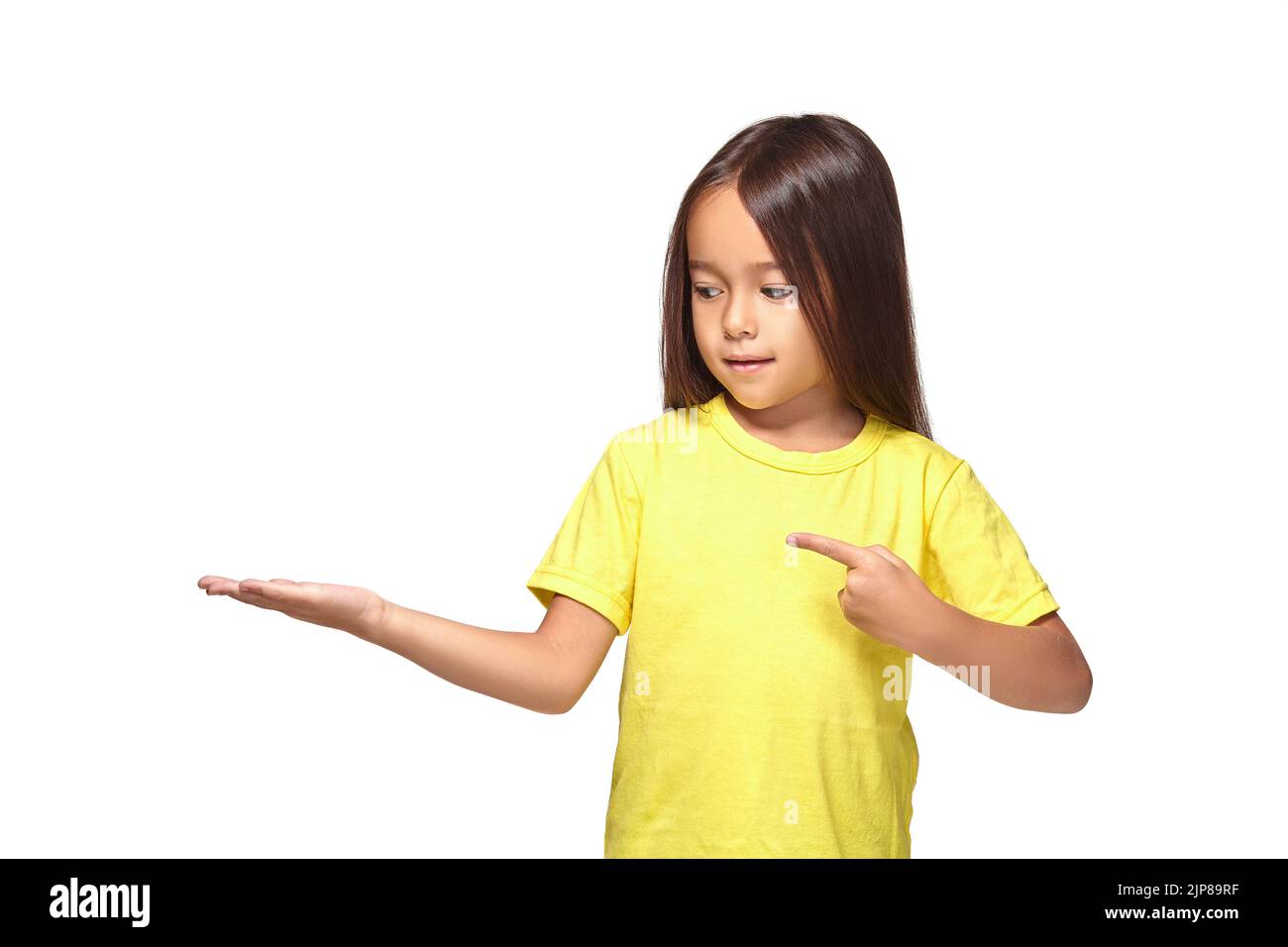 Little girl in yellow t-shirt holding her hand out Stock Photo - Alamy