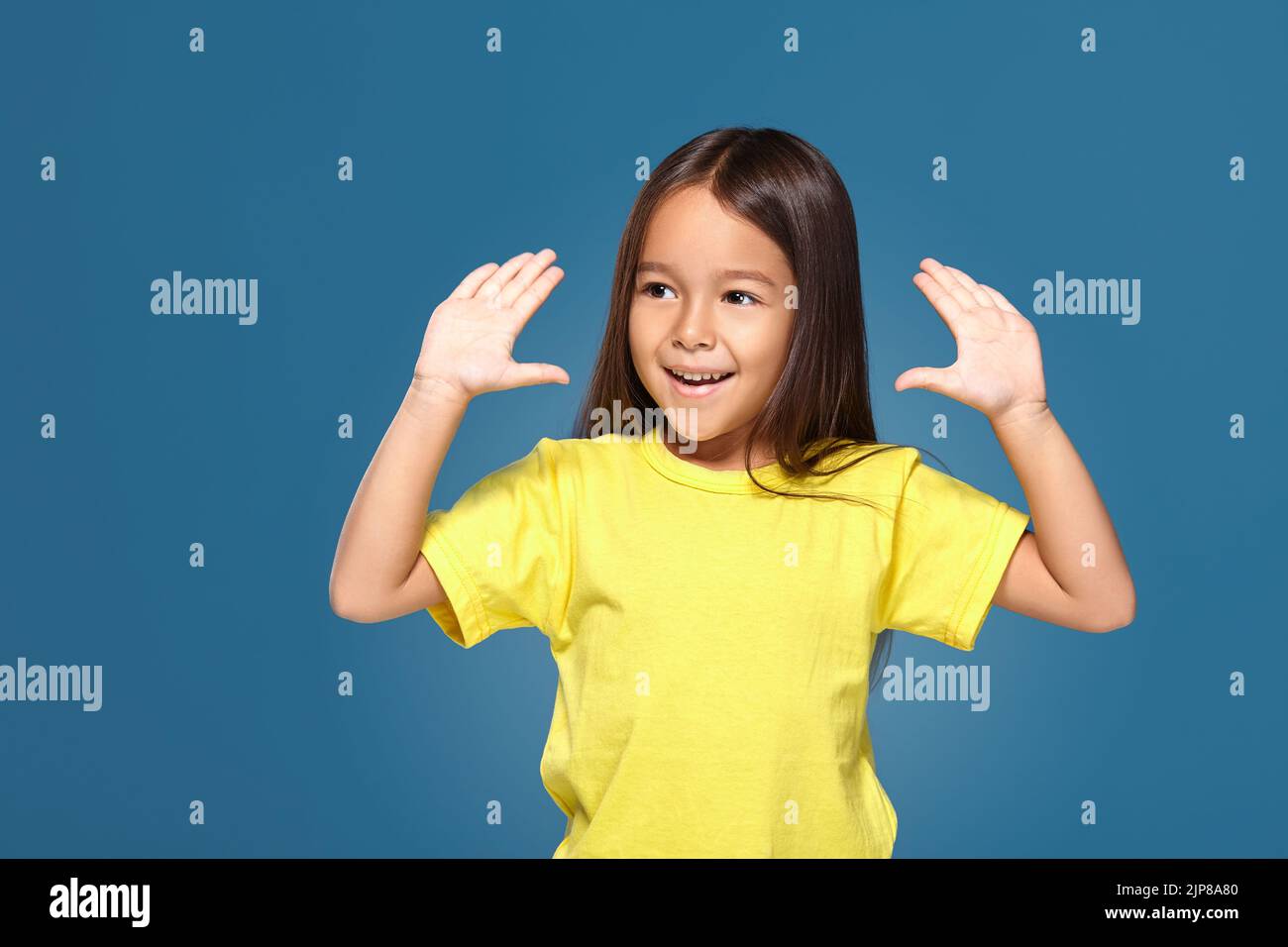 Little girl in raising her hands up Stock Photo - Alamy