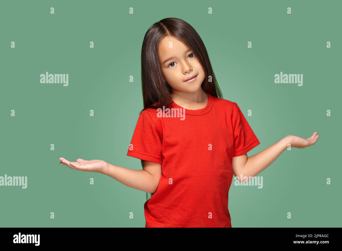 Surprised girl with spread arms isolated on green background Stock ...