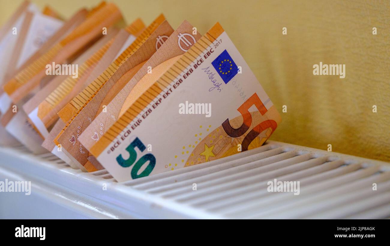 Euro banknotes in central heating radiator, concept of expensive ...