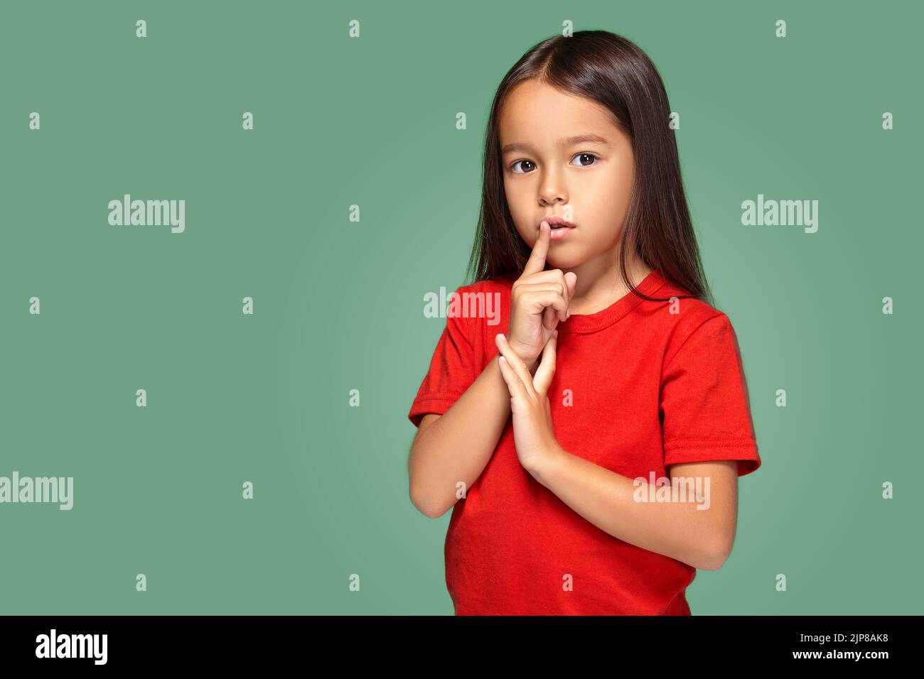 girl placing finger on lips asking shh, quiet, silence Stock Photo - Alamy