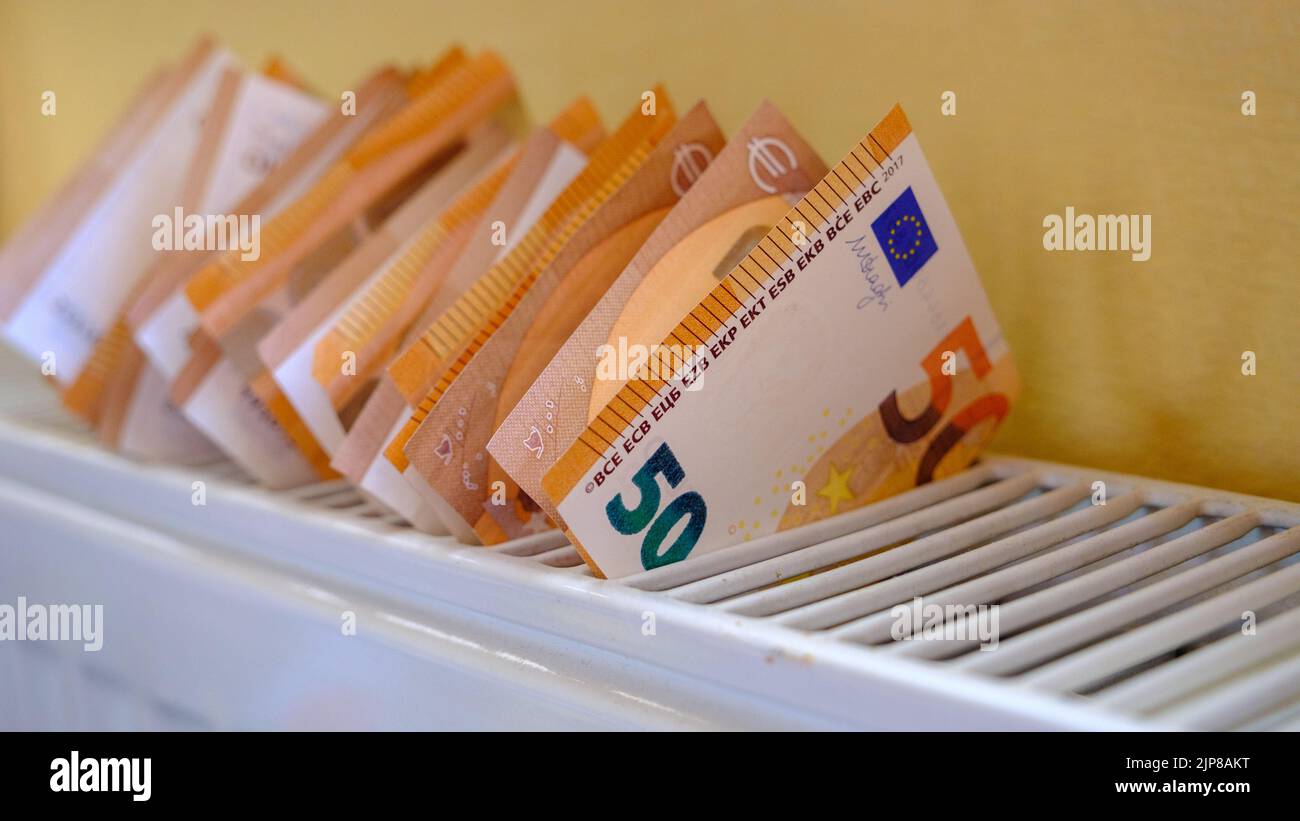Euro banknotes in central heating radiator, concept of expensive ...