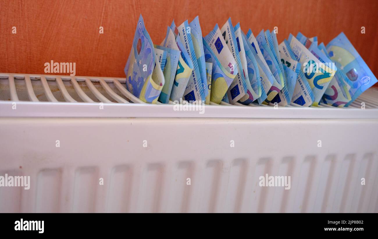 Euro banknotes in central heating radiator, concept of expensive ...