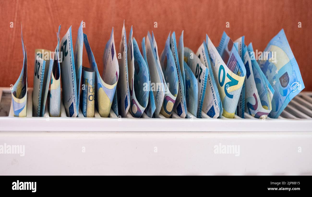 Euro banknotes in central heating radiator, concept of expensive ...