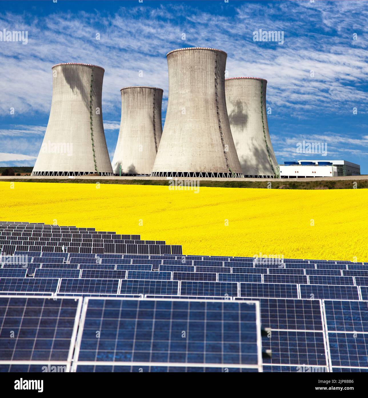 Nuclear power plant with golden flowering field of rapeseed and ...