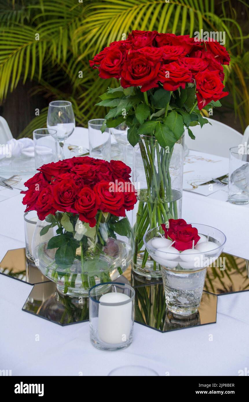 Bouquet of red roses decorates a table at a festive celebration and ...