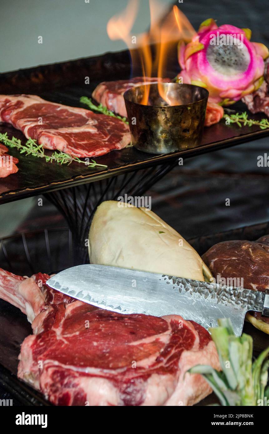 Cuts of Raw Meat on display at a posh buffet Stock Photo - Alamy