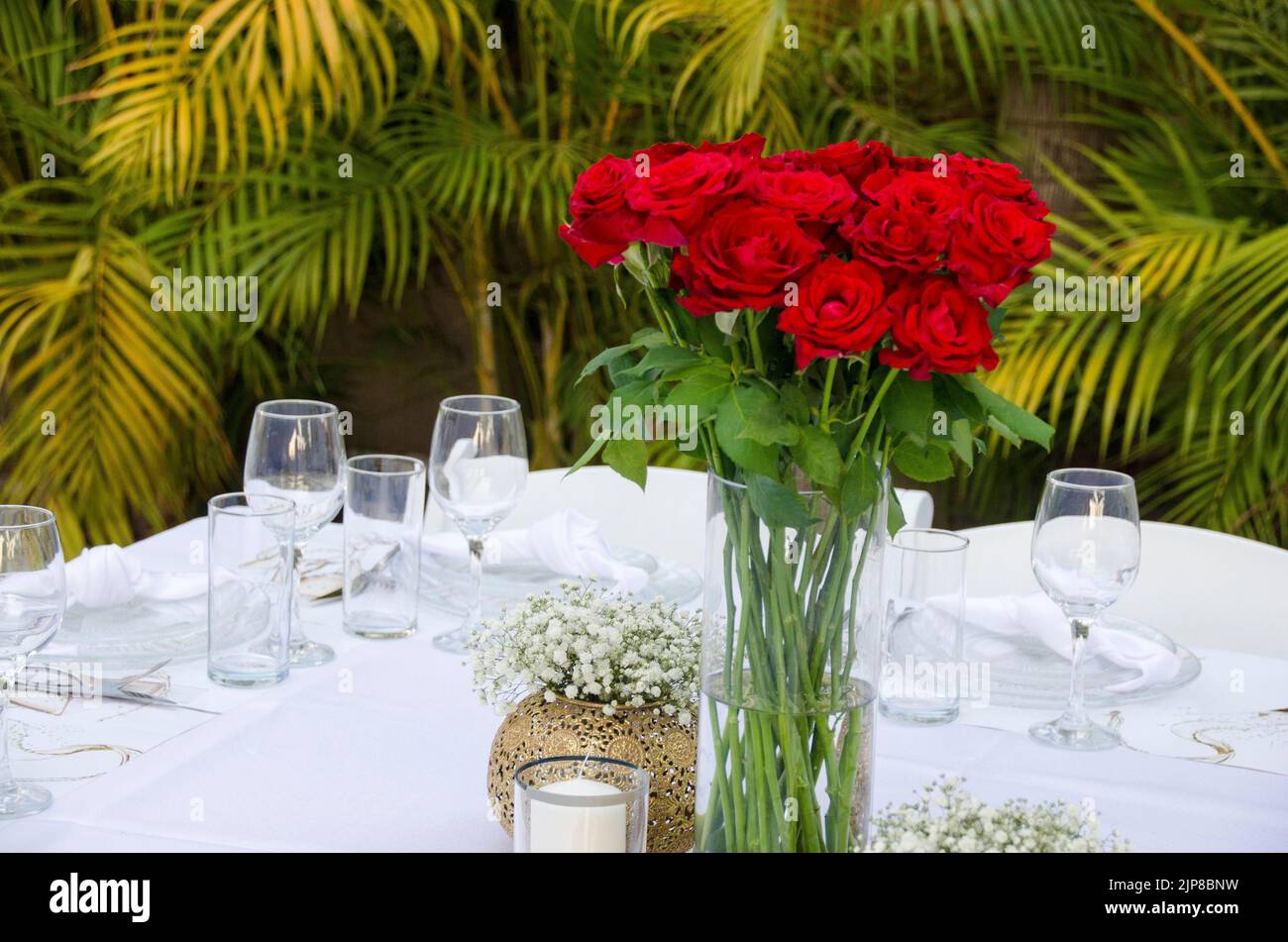 Bouquet of red roses decorates a table at a festive celebration and ...