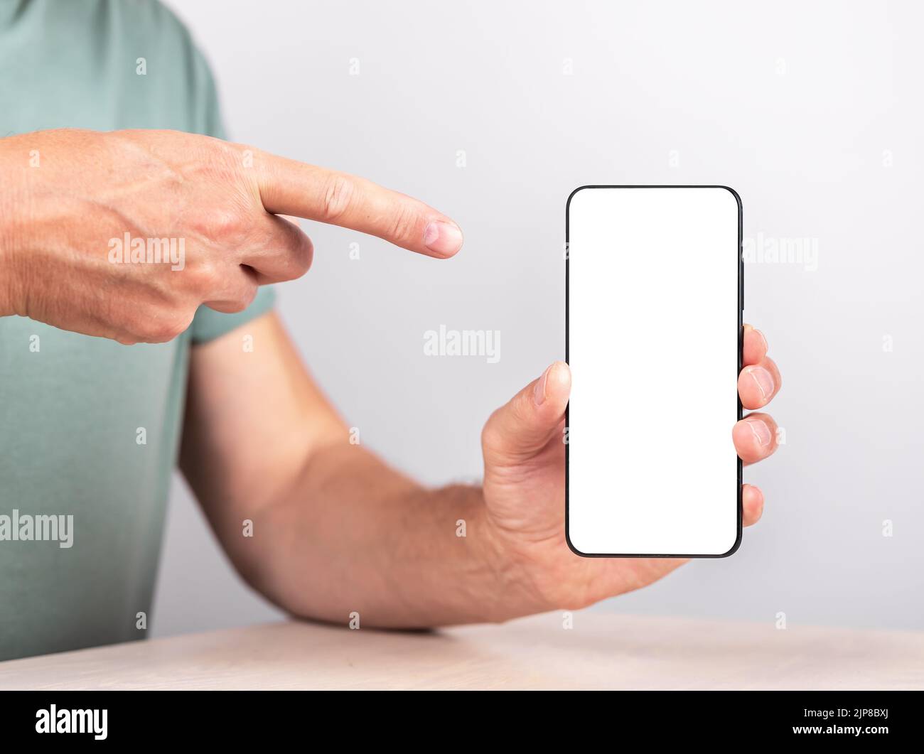 Man forefinger pointing to phone mockup in vertical position. Male ...