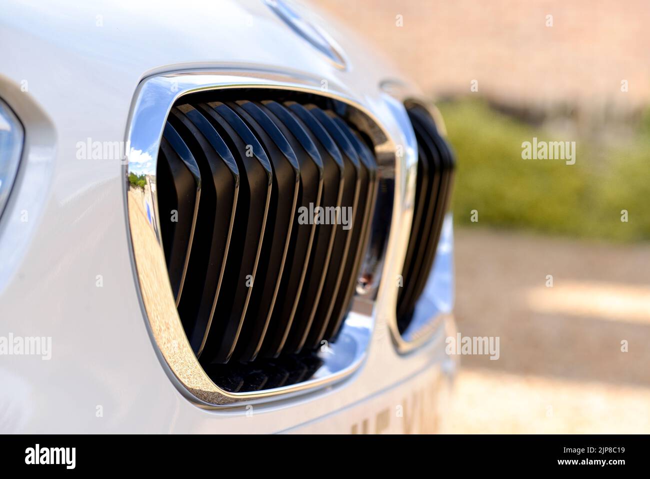 A close-up shot of a front grill of the white vehicle Stock Photo - Alamy