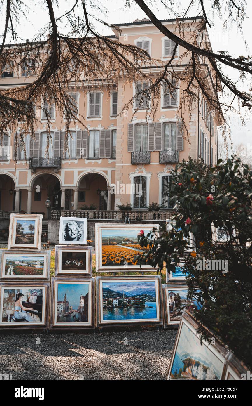 A selection of paintings placed in the front yard of a hotel in Stresa ...