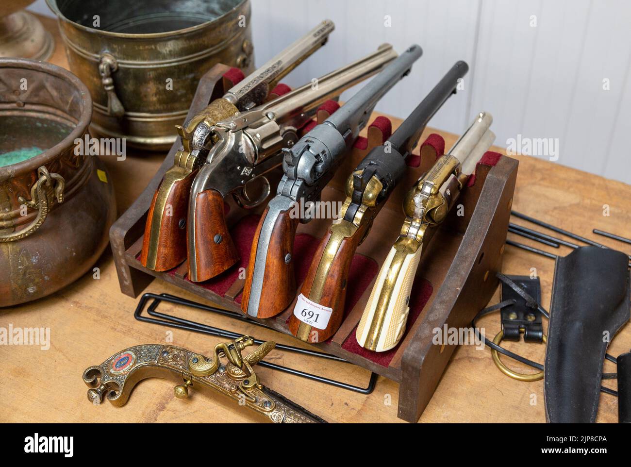 A selection of vintage hand guns on display in auction room, UK Stock ...
