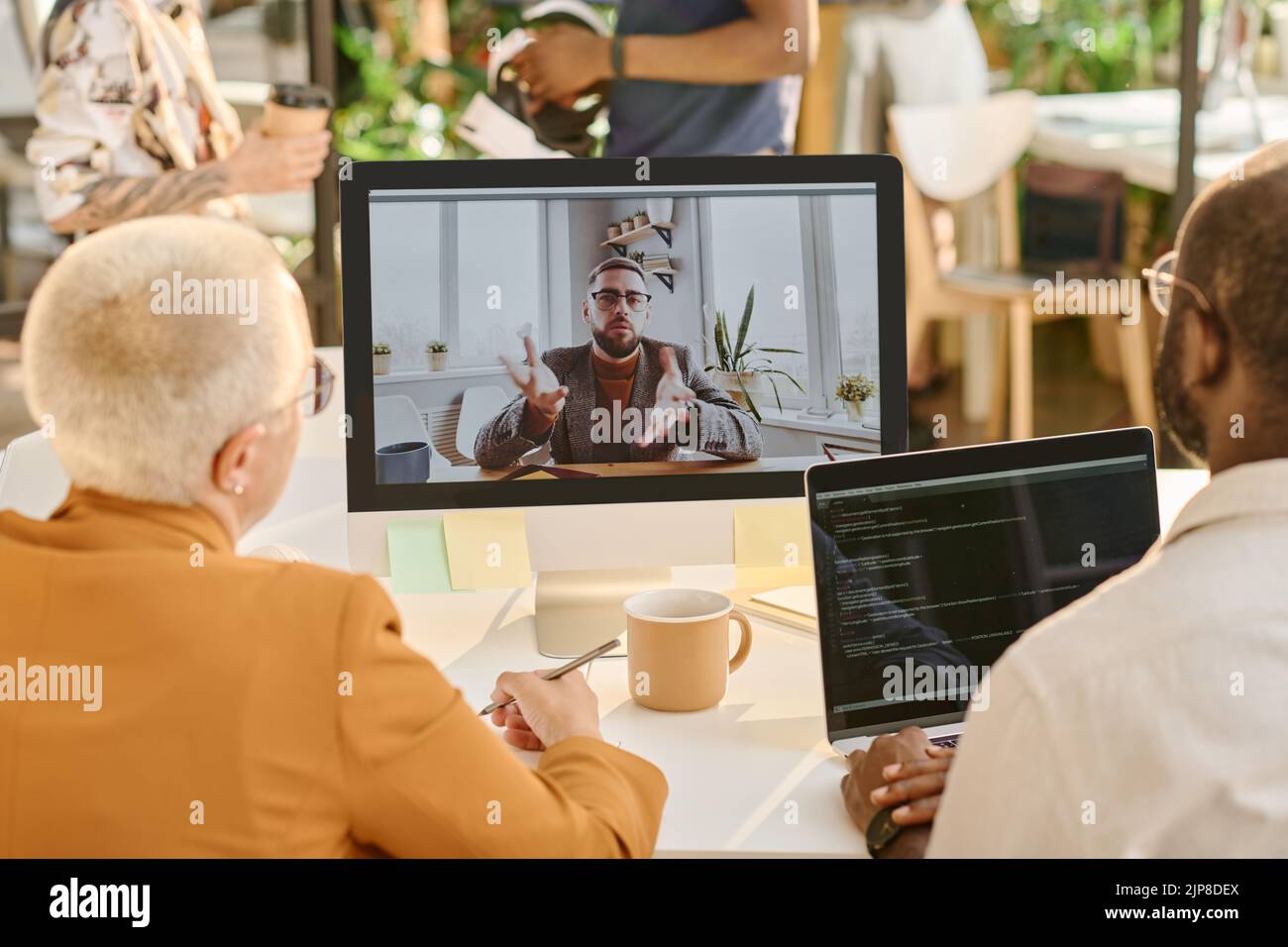 Programmer having video call colleague hi-res stock photography and ...