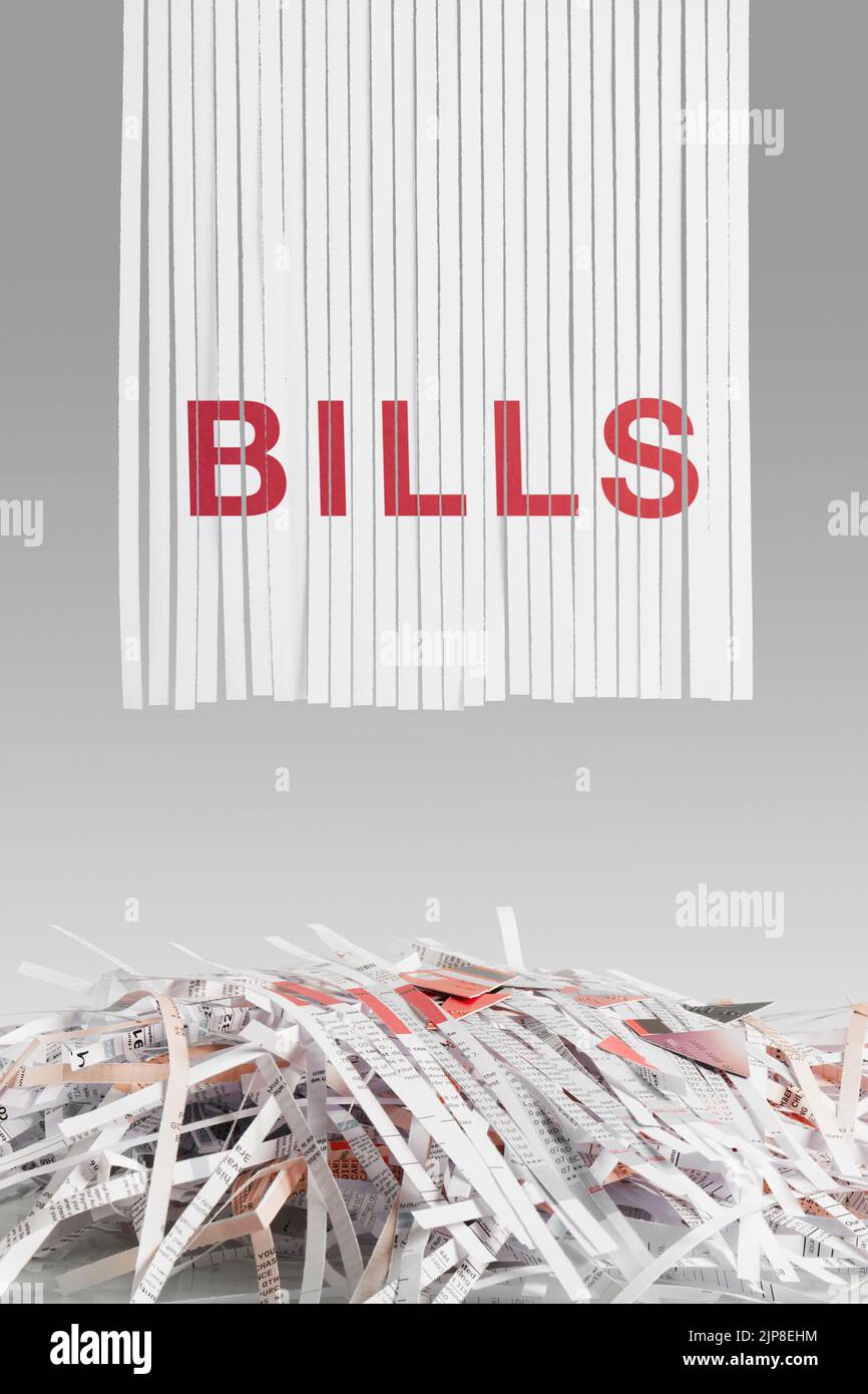 Shredded red BILLS letters above Cut up credit cards on Shredded Bills ...