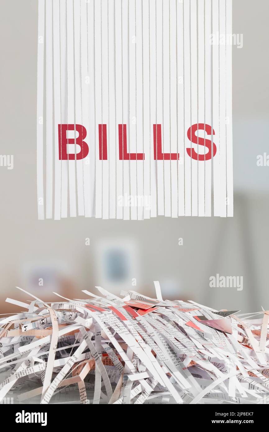 Shredded red BILLS letters above Cut up credit cards on Shredded Bills ...