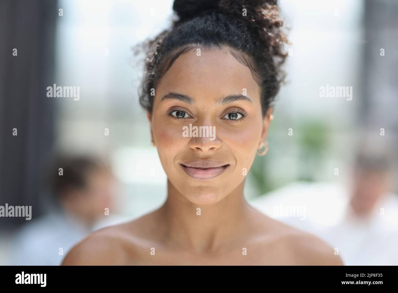 a business woman smiling inside office building Stock Photo - Alamy