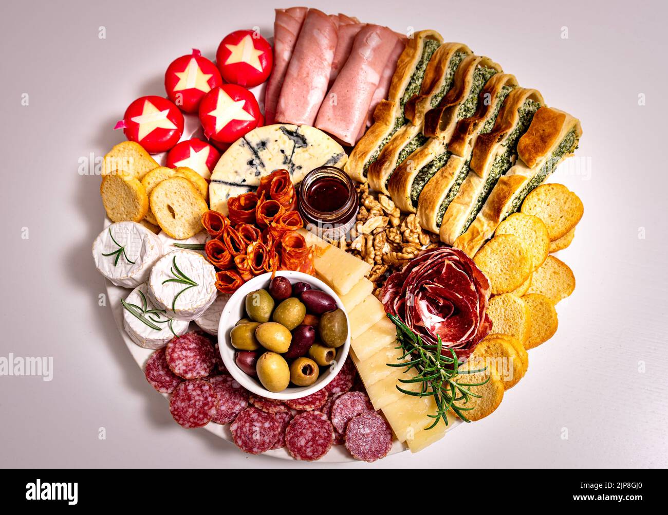 Top view of lunch or appetiser with a dish with salami, pepperoni, brie ...