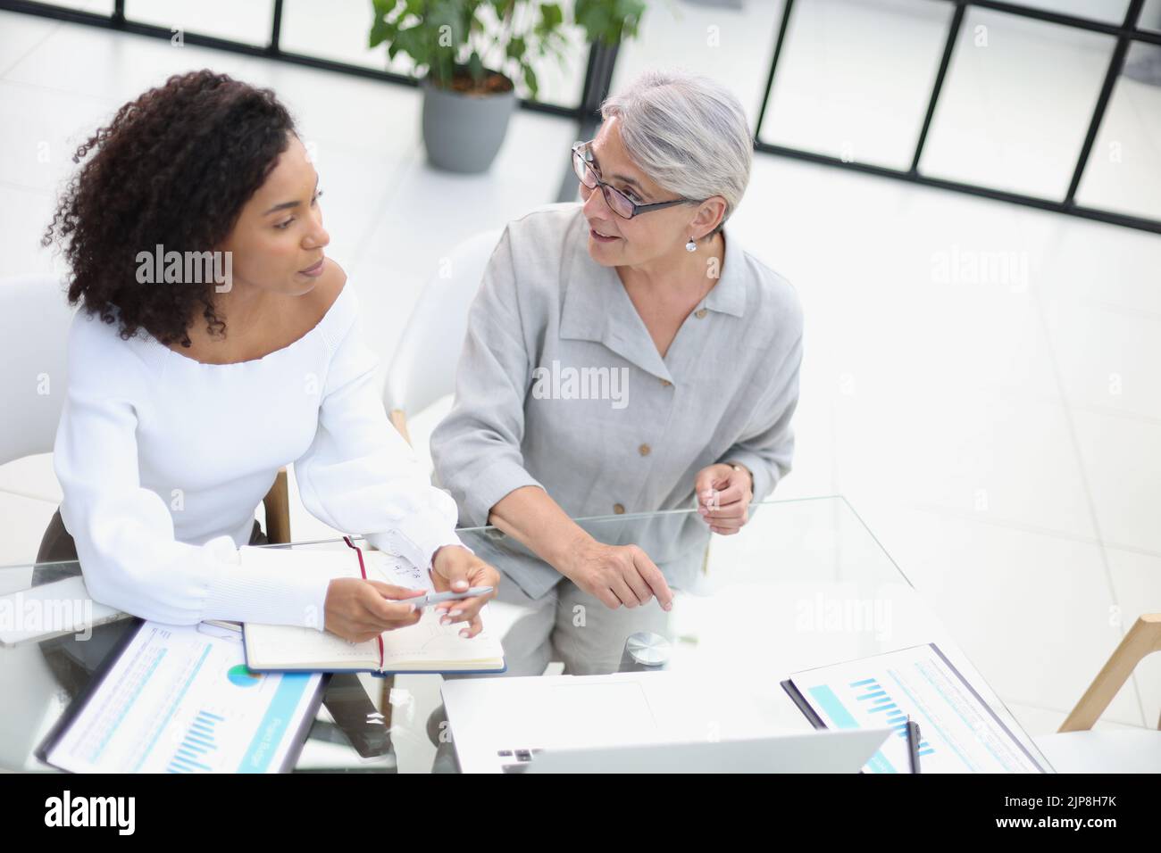 Female colleagues of different nationalities and ages met in the office ...