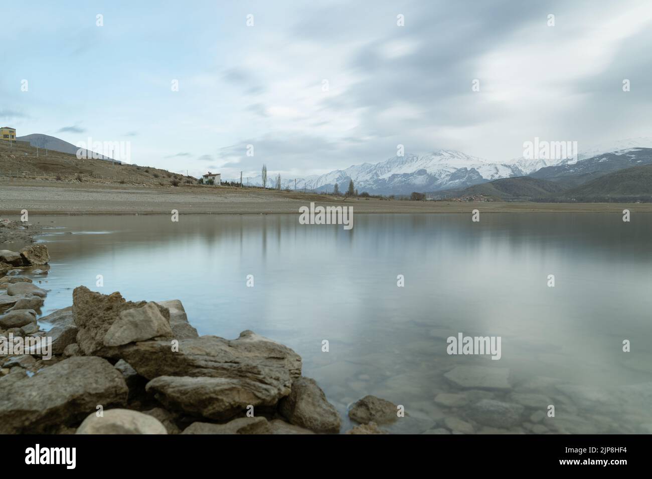 Lake and snowy mountain reflection view, long exposure landscape Stock ...