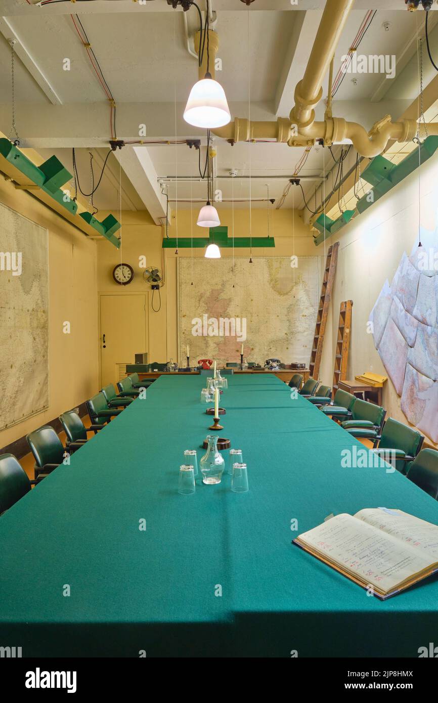 One of the meeting rooms, with a long, green table and a map made of ...